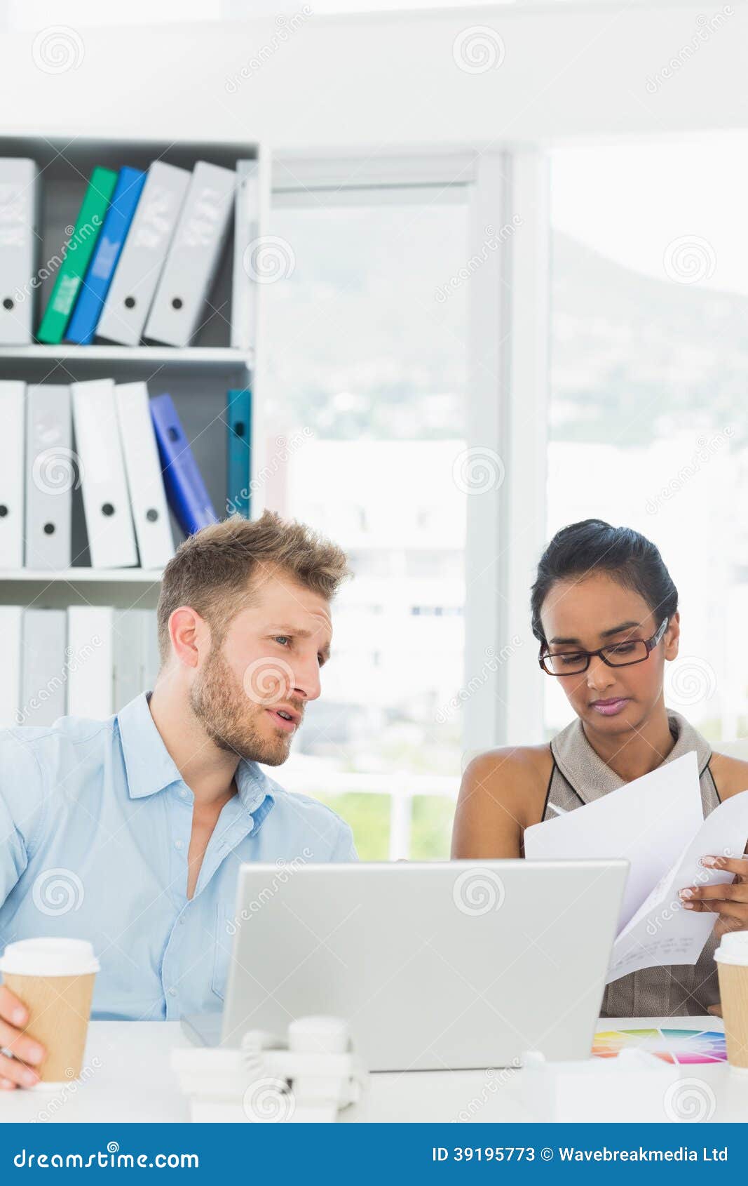 Focused Partners Working Together on Laptop at Desk Stock Image - Image ...
