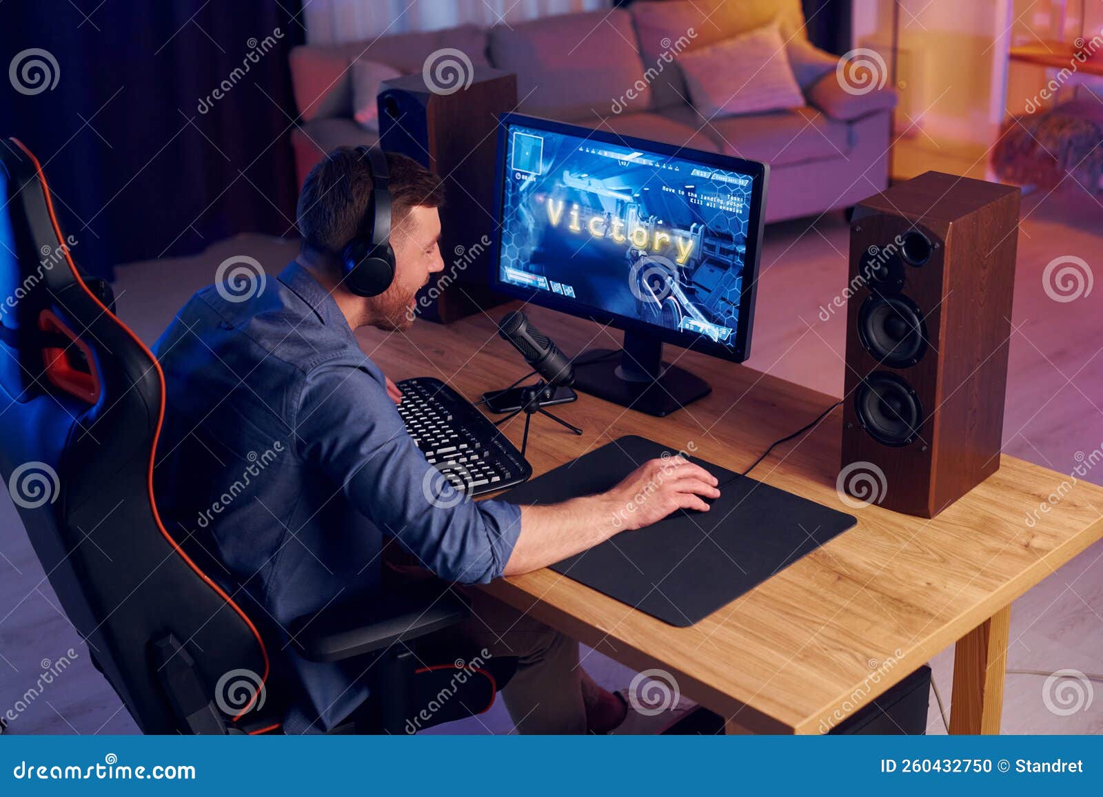 Focused on the Playing. Man Streaming FPS Shooter Game at Home Stock ...