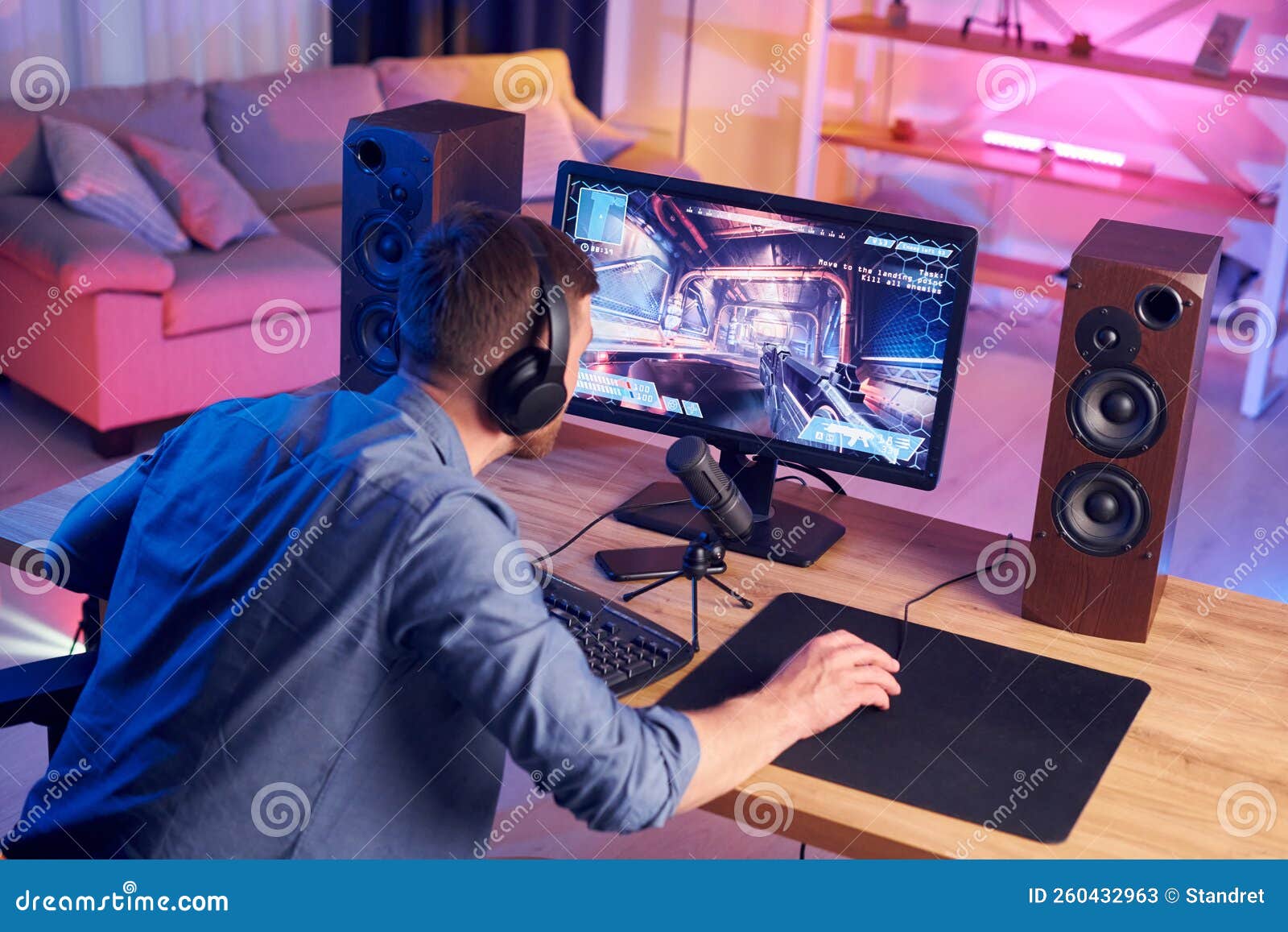 Focused on the Playing. Man Streaming FPS Shooter Game at Home Stock ...
