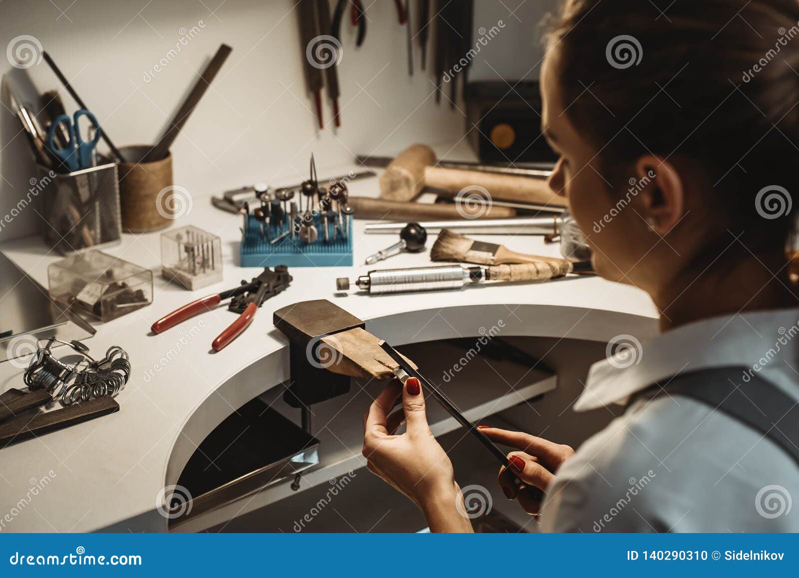 Focused on a Process. Back View of a Female Jeweler Working and Shaping ...