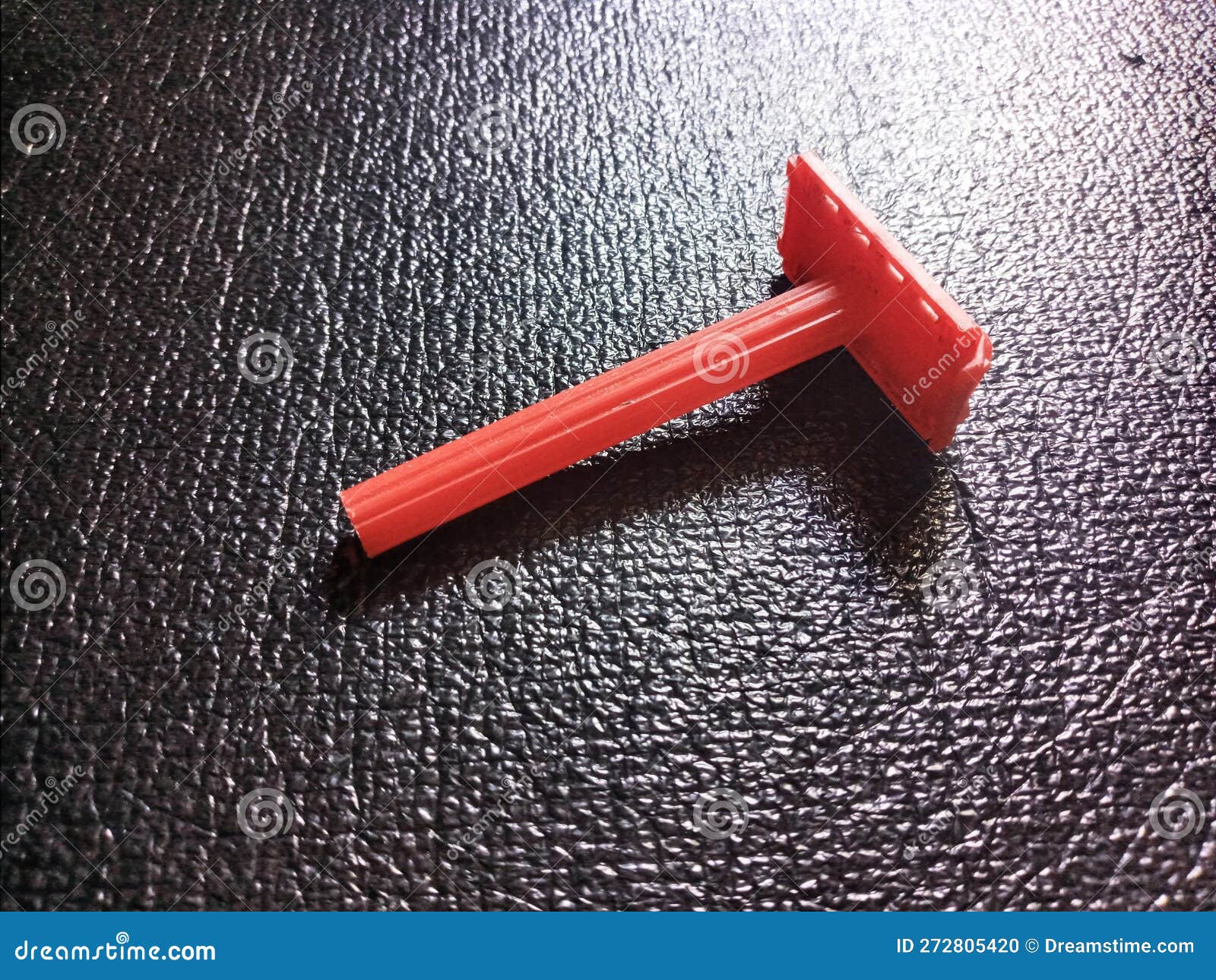 Focused Red Razor on Black Wrinkled Surface Stock Photo - Image of ...