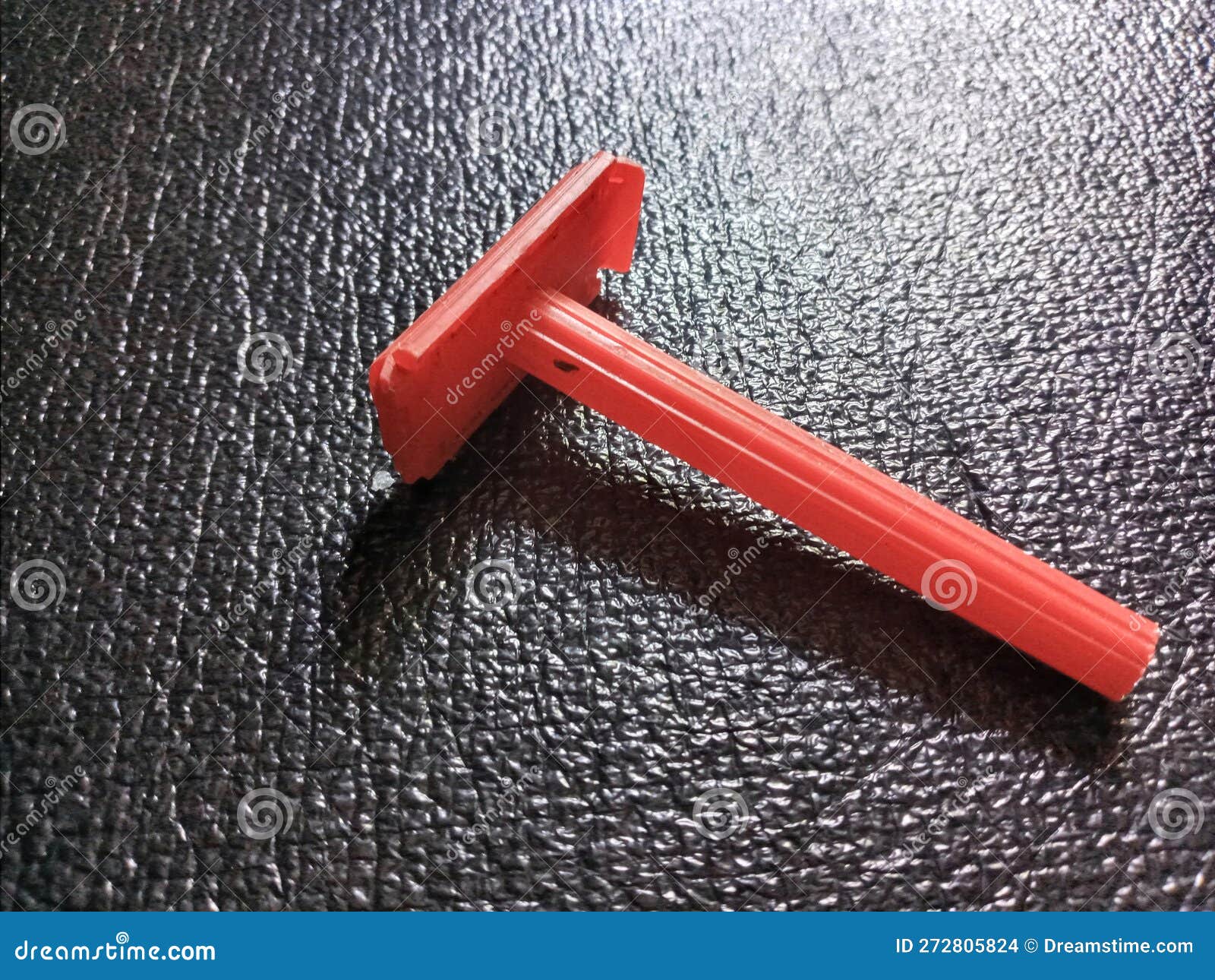 Focused Red Razor on Black Wrinkled Surface Stock Photo - Image of ...