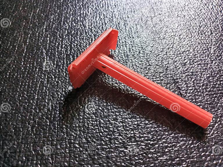 Focused Red Razor on Black Wrinkled Surface Stock Photo - Image of ...