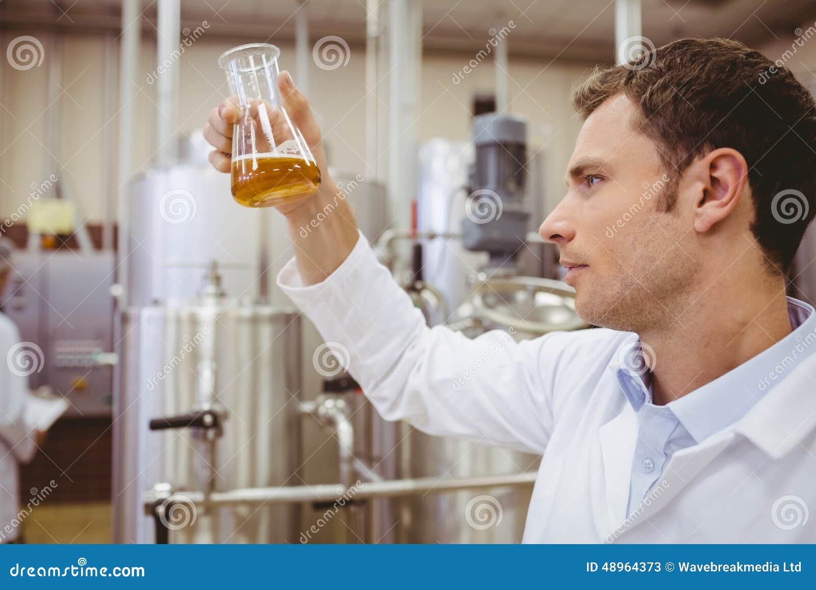 Focused Scientist Looking Beaker with Beer Stock Image - Image of ...