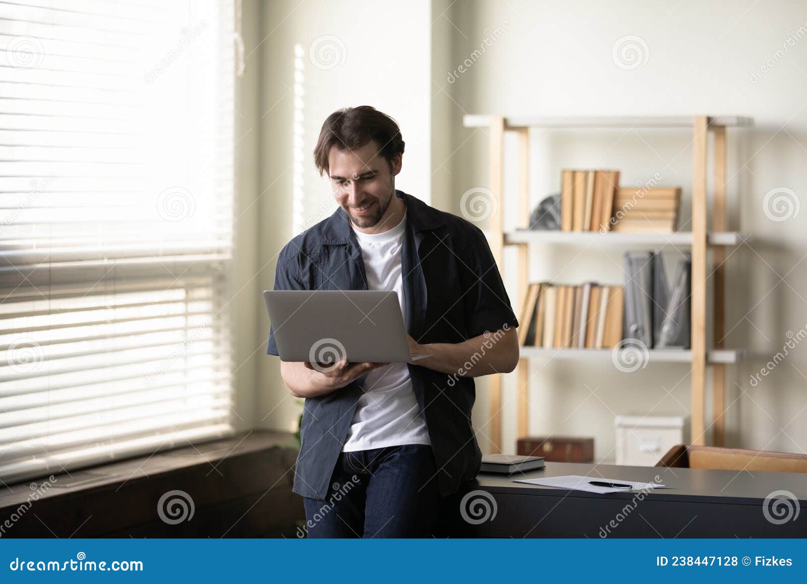 Focused Smiling Young Man Working on Computer. Stock Photo - Image of ...