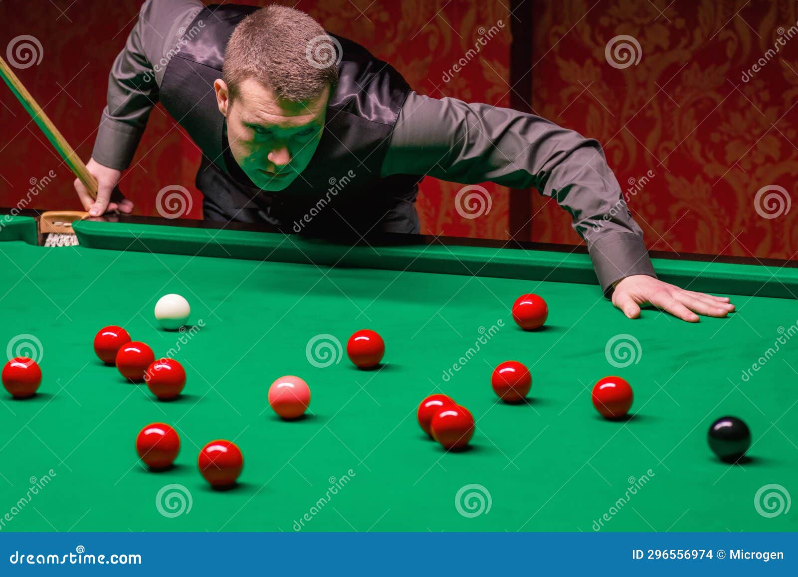 A Focused Snooker Player Demonstrating Skill and Precision during a ...