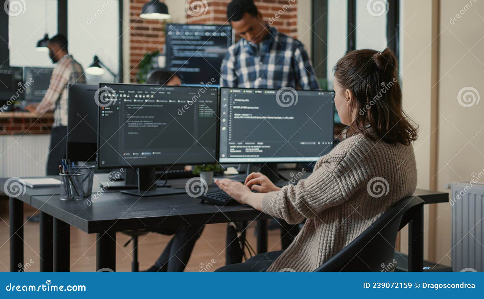 Focused Software Developer Writing Code Looking at Multiple Computer ...