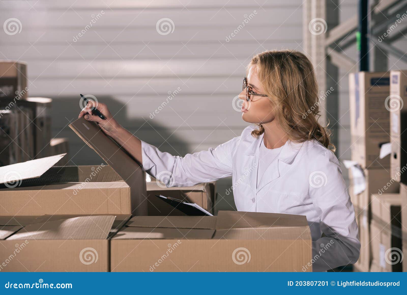Focused Storekeeper in White Coat Inspecting Stock Image - Image of ...