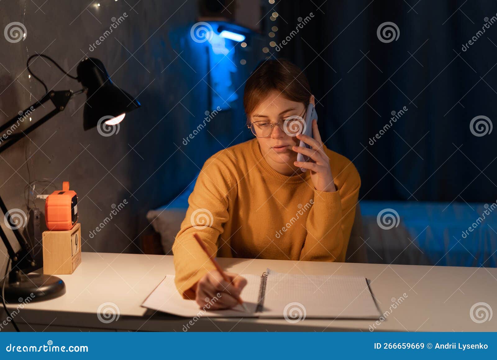 Focused Student in Dormitory Room Sitting at Table with Notebook and ...