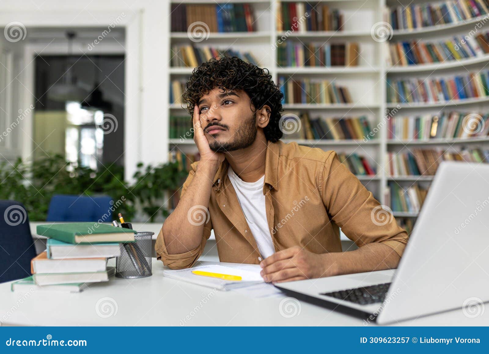 University Student Studying in Library for Exam Preparations Stock ...