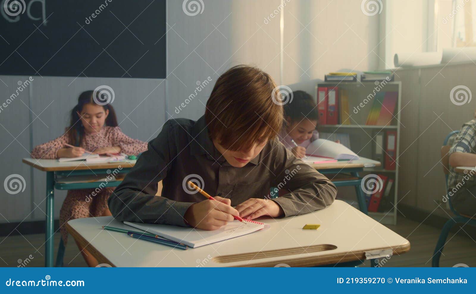 Focused Student Schooling in Classroom. Diligent Pupil Writing in ...