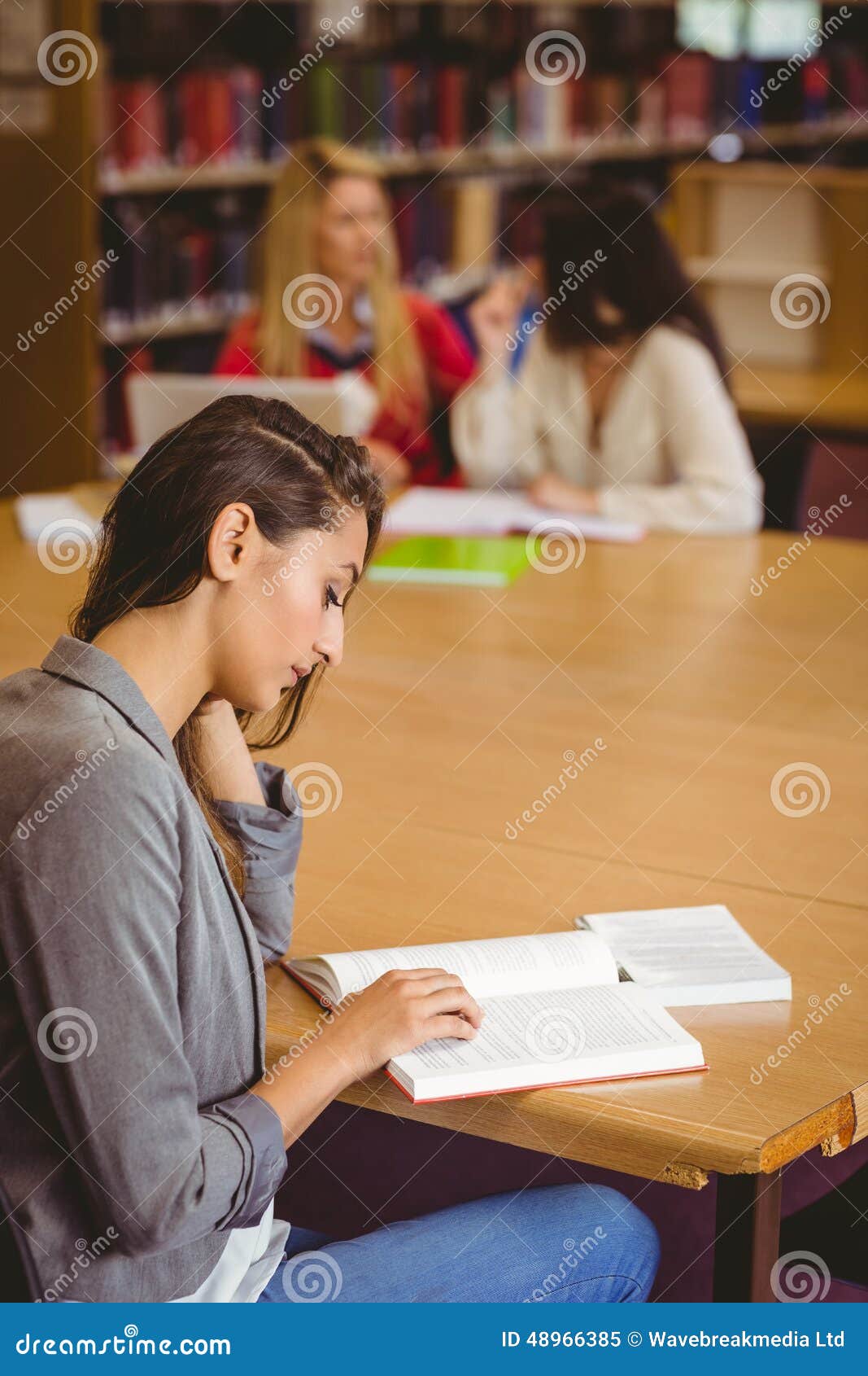 Focused Student Sitting at Desk Reading Text Book Stock Image - Image ...