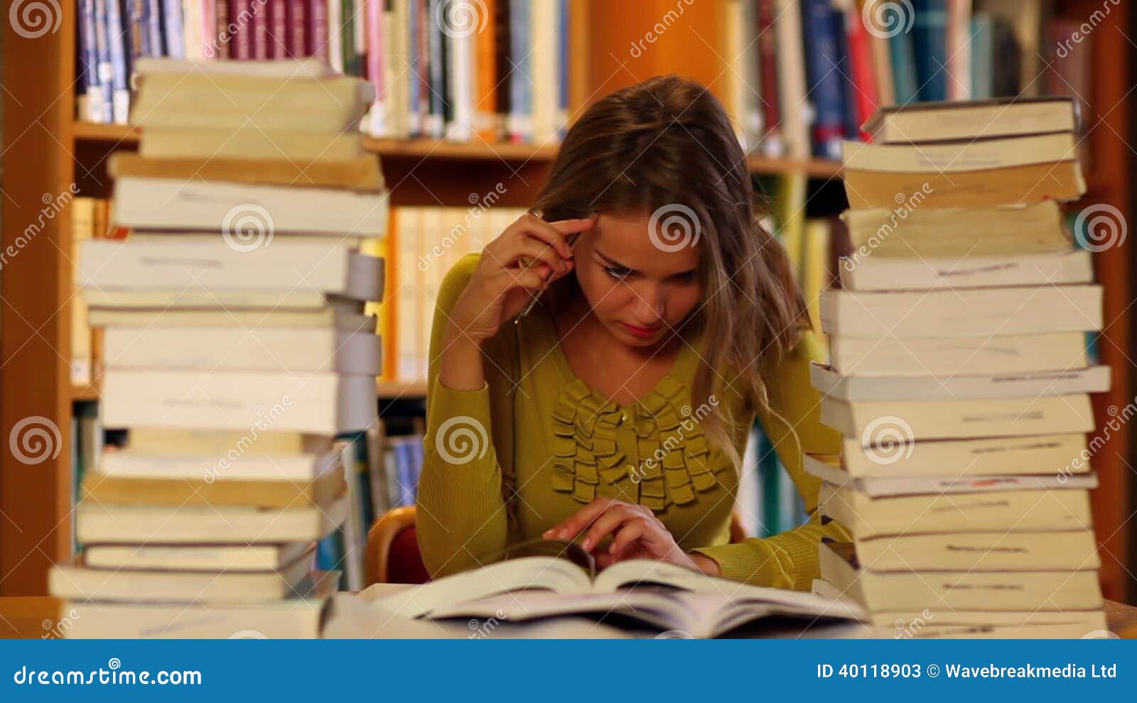Focused Student Studying in the Library Surrounded by Books Stock Video ...