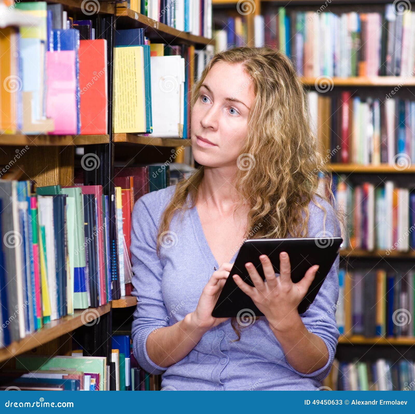 Focused Student Using a Tablet Computer in a Library Stock Image ...
