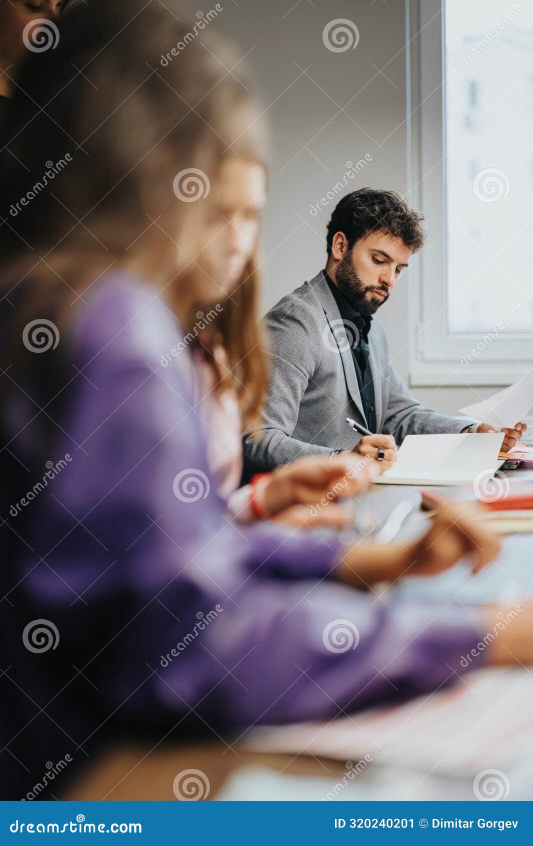 Focused Team of Professionals Engaged in a Strategic Meeting at a ...