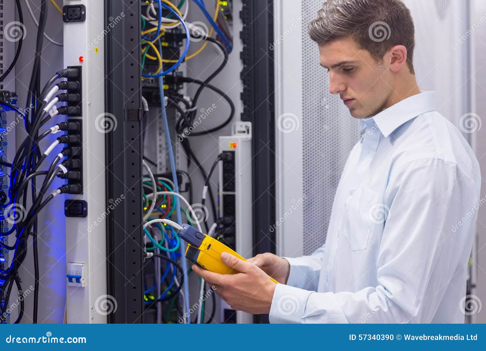 Focused Technician Using Digital Cable Analyser on Servers Stock Photo ...