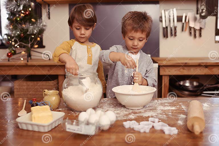 Focused on Their Baking. Two Young Brothers Baking in the Kitchen ...