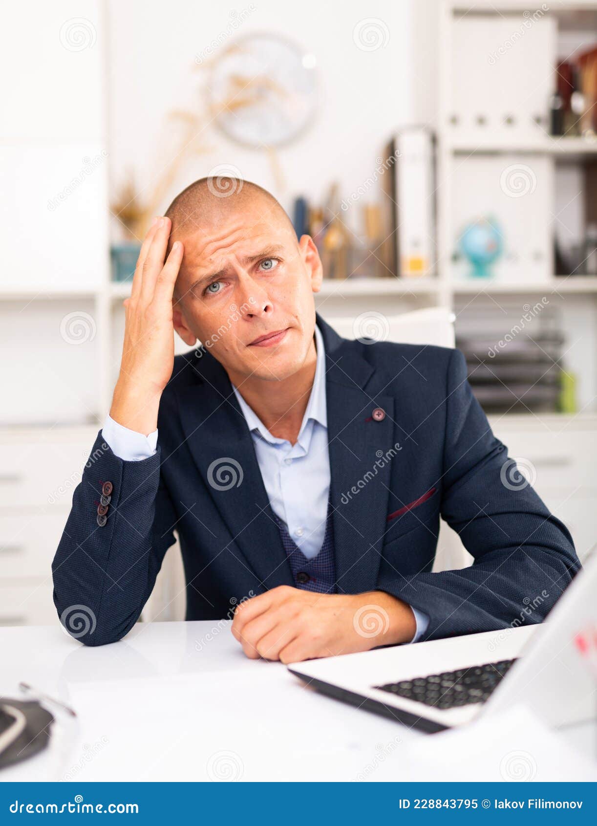 Thoughtful Young Man Working with Laptop and Documents Stock Image ...