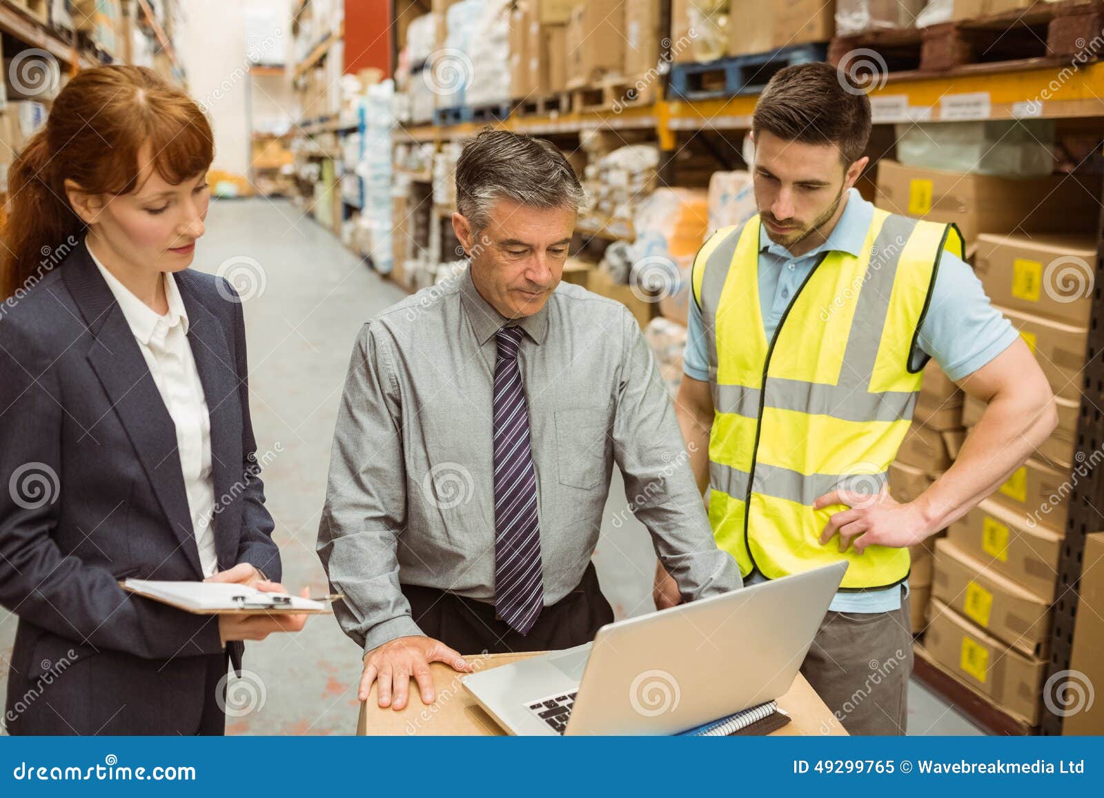 Focused Warehouse Team Working Together on Laptop Stock Image - Image ...