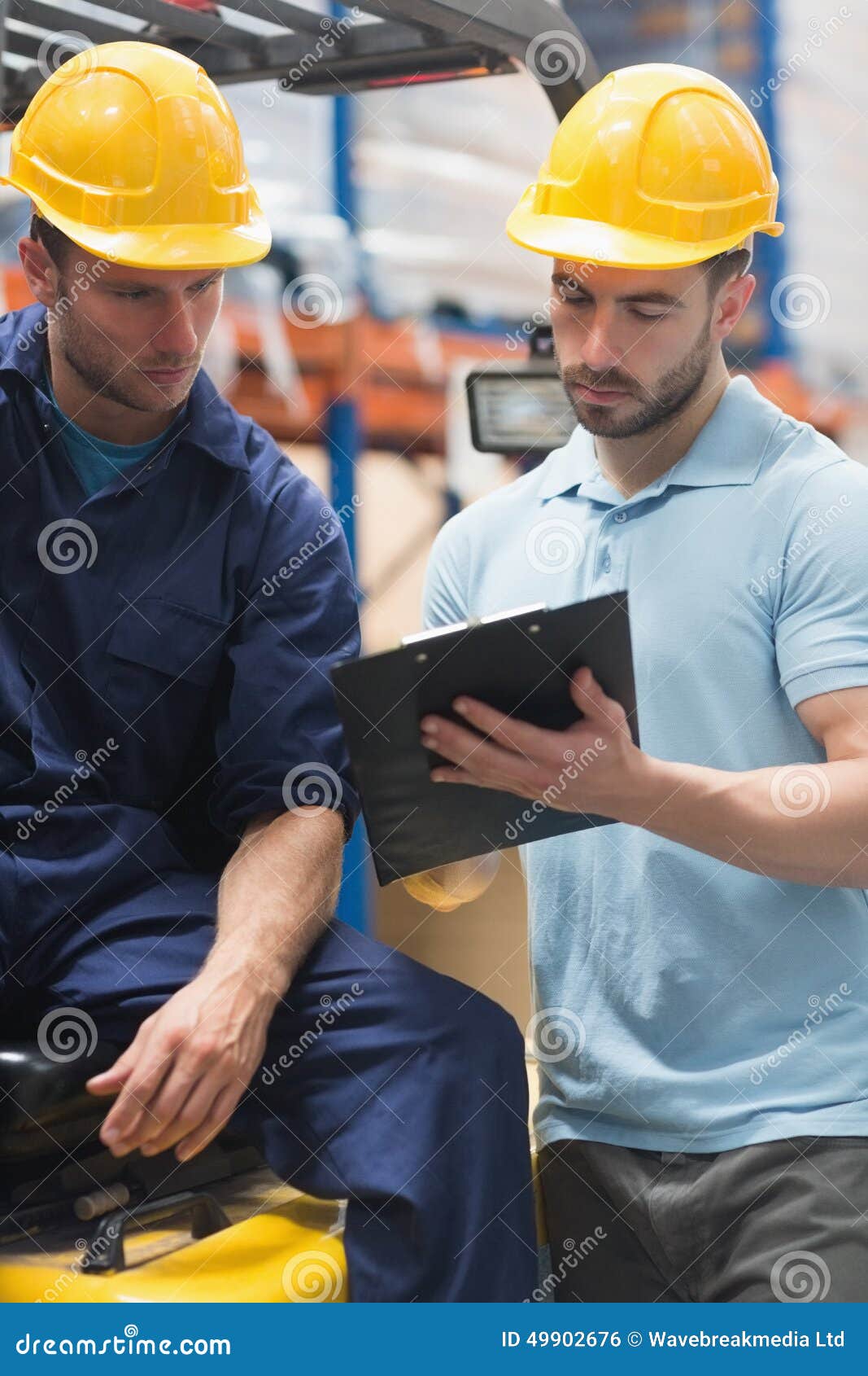 Focused Warehouse Workers Talking Together Stock Photo - Image of ...