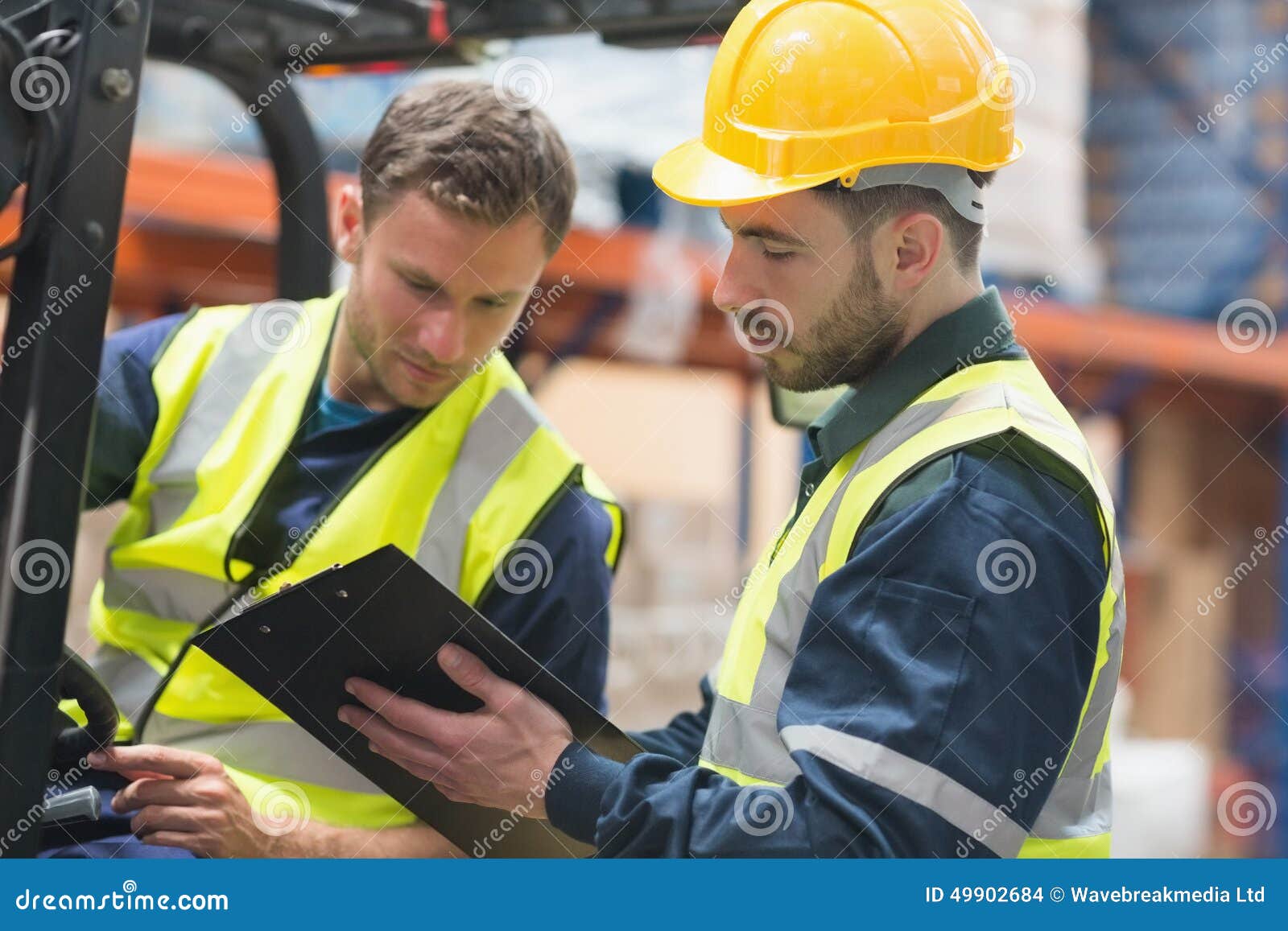 Focused Warehouse Workers Talking Together Stock Photo - Image of ...