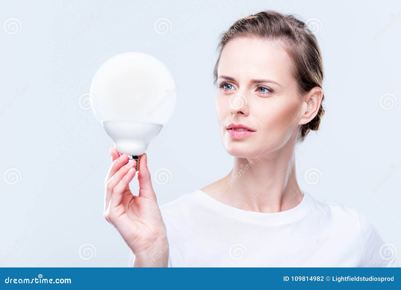 Focused Woman with Light Bulb Stock Photo - Image of casual, hold ...
