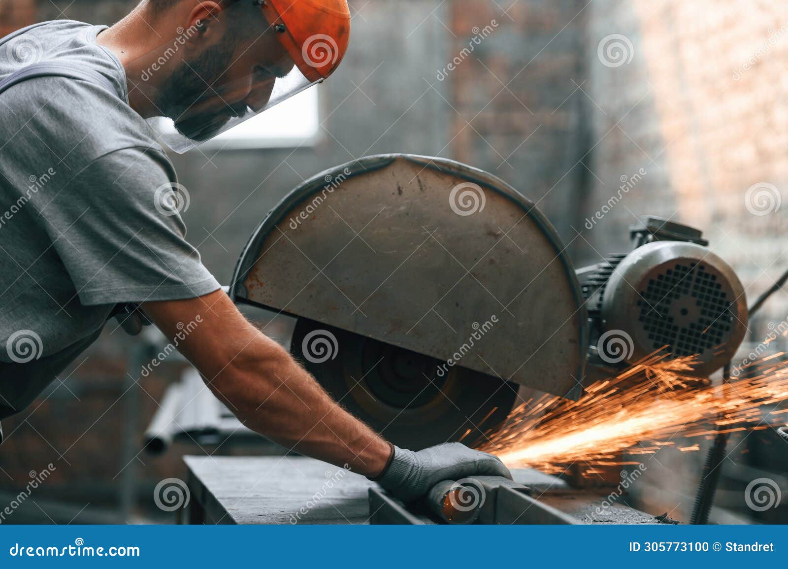 Focused at Work, Cutting the Metal. Young Man at Factory in Grey ...