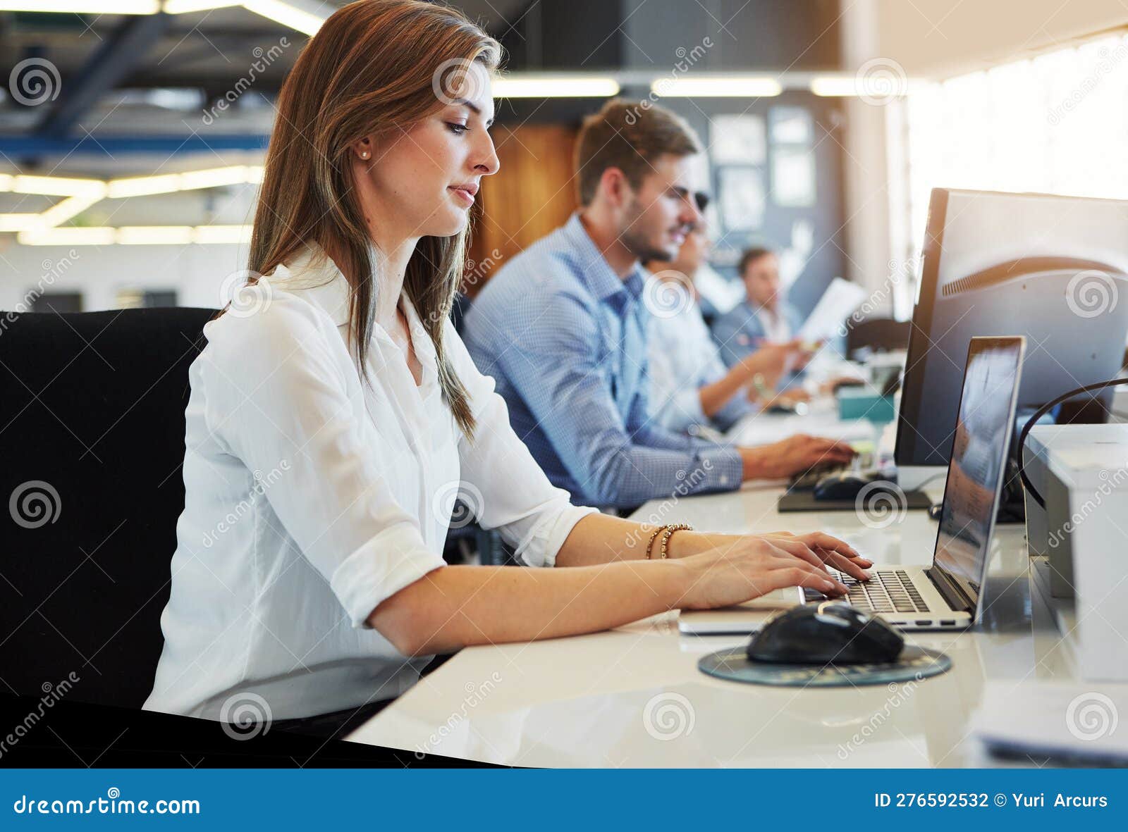 Focused on the Work in Front of Her. a Group of Businesspeople Working ...