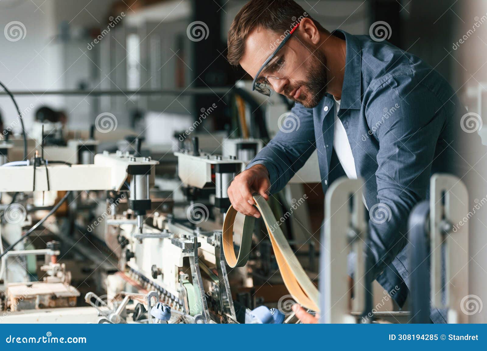 Focused by Working with Machine. Handsome Man is at the Factory of ...