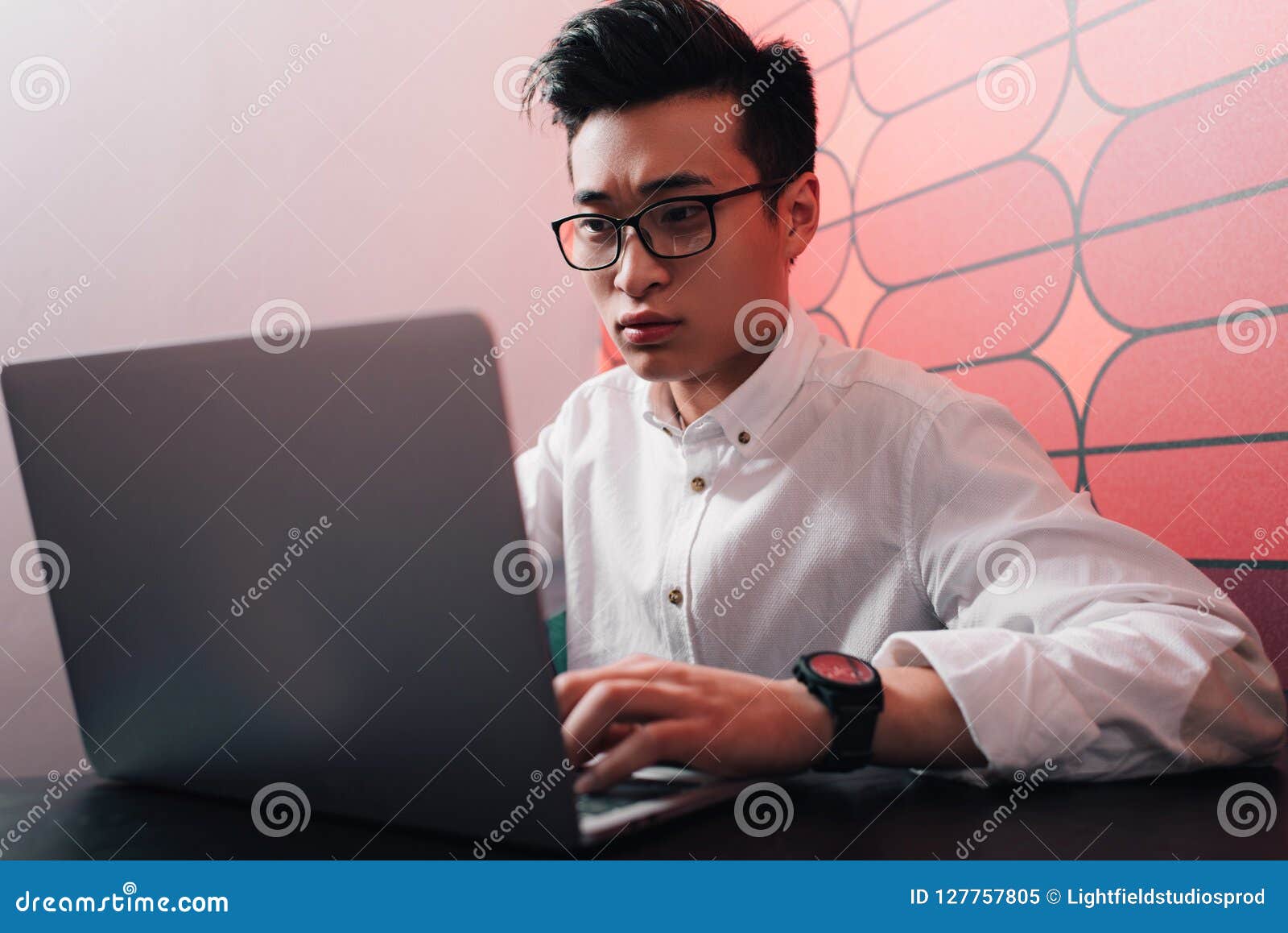 Focused Young Asian Businessman Working at Table with Laptop Stock ...