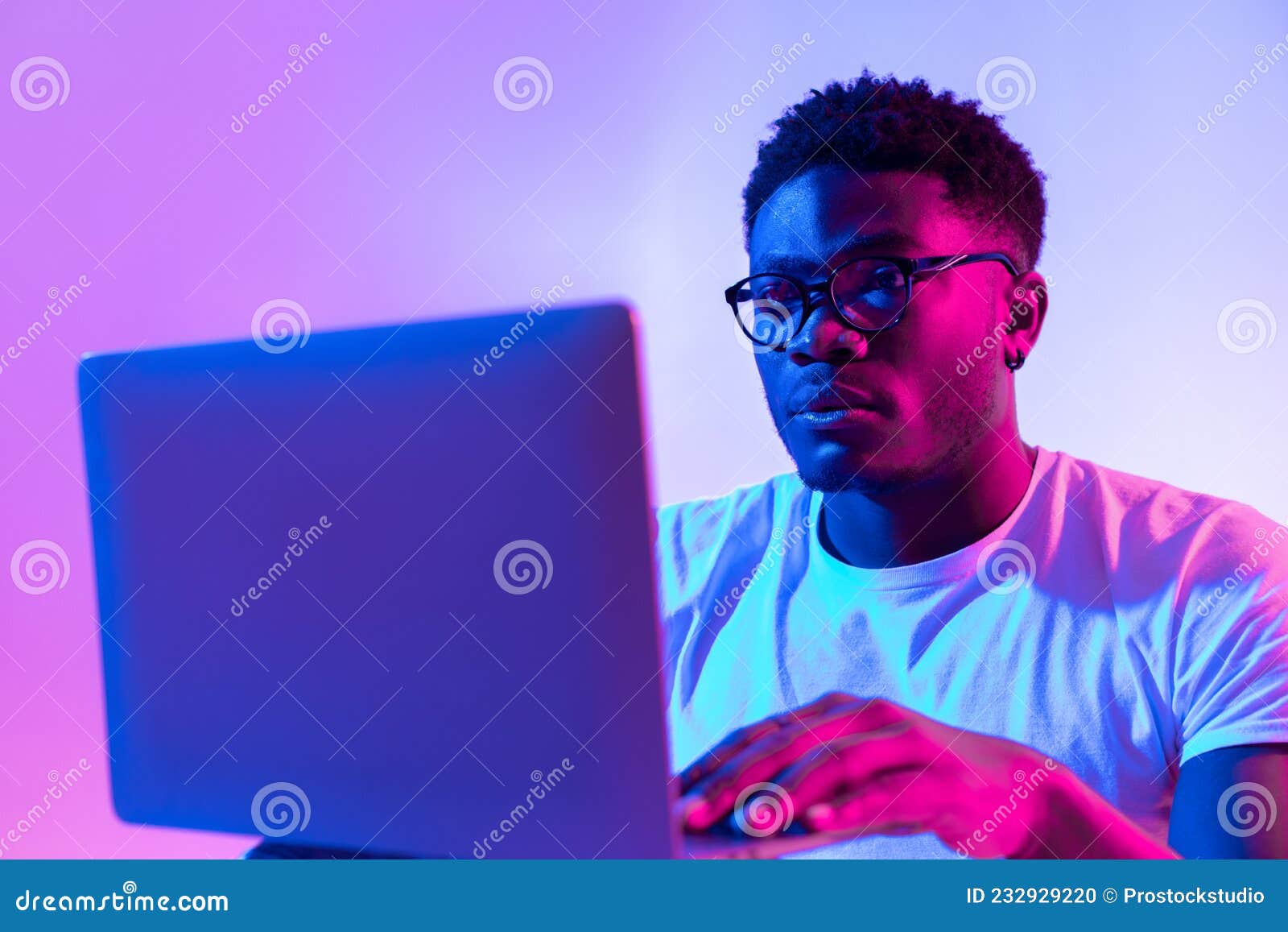 Focused Young Black Man in Glasses Using Laptop Computer for Online ...
