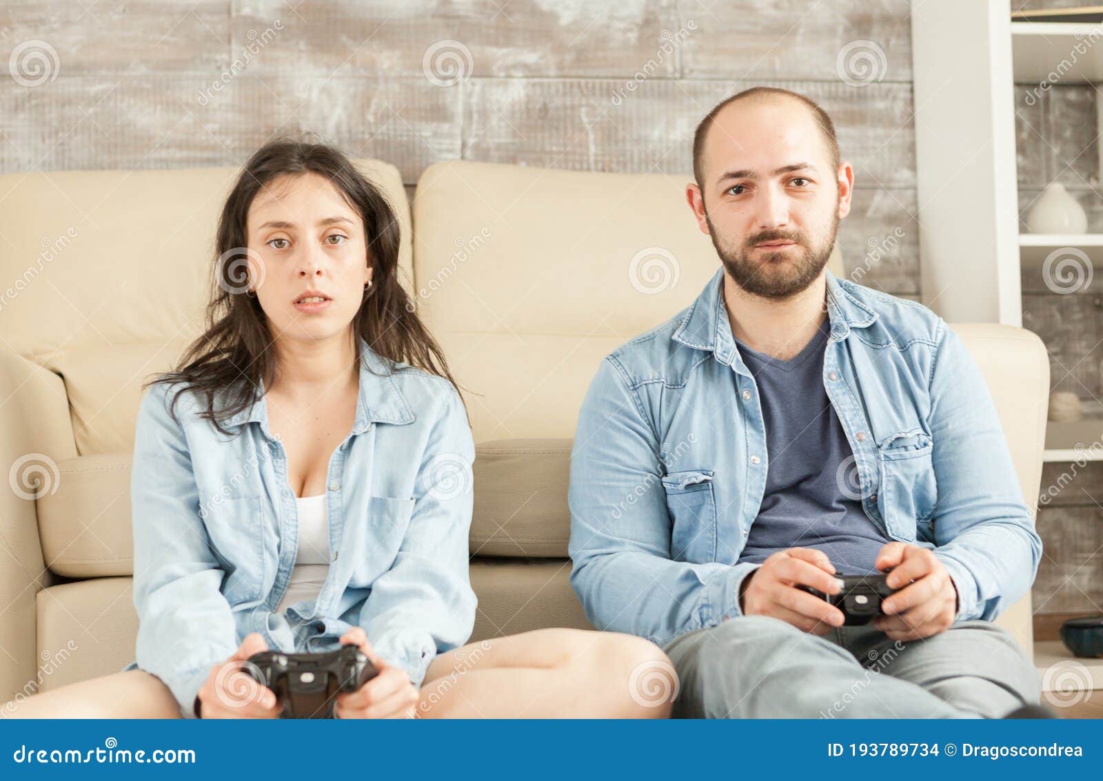 Focused young couple stock photo. Image of joystick - 193789734