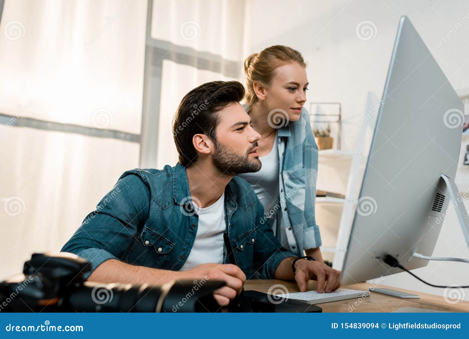 Focused Young Designers Working with Desktop Computer and Stock Photo ...