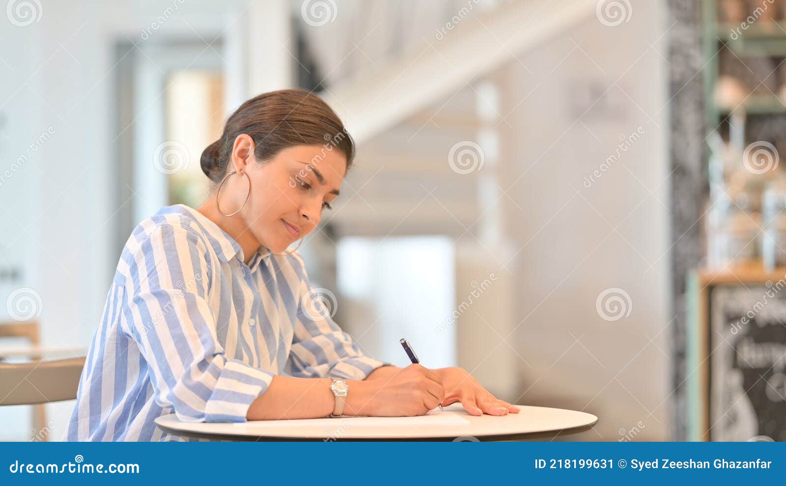 Focused Young Indian Woman Doing Paperwork in Cafe Stock Image - Image ...