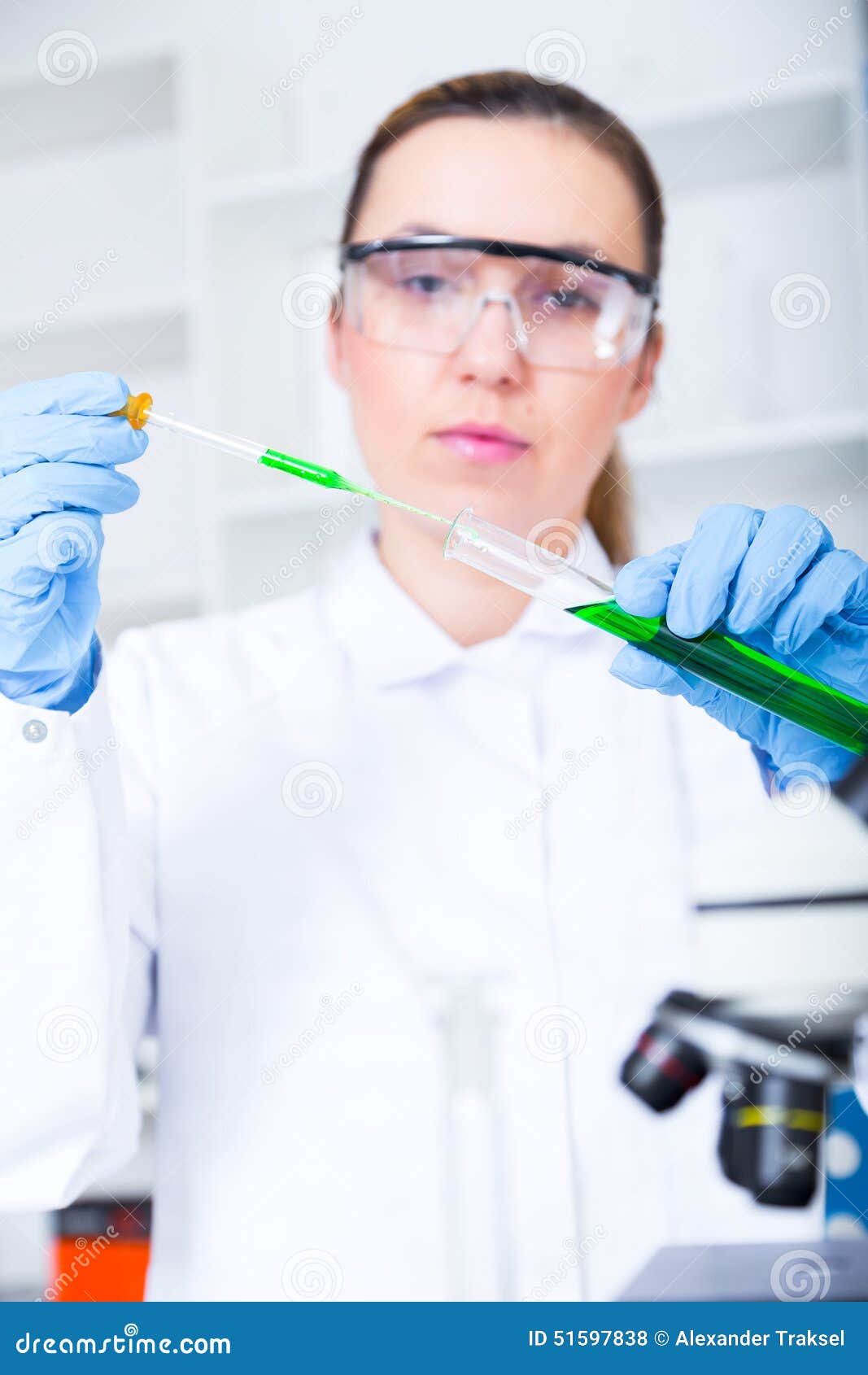 Focused Young Life Science Professional Pipetting Solution into the ...