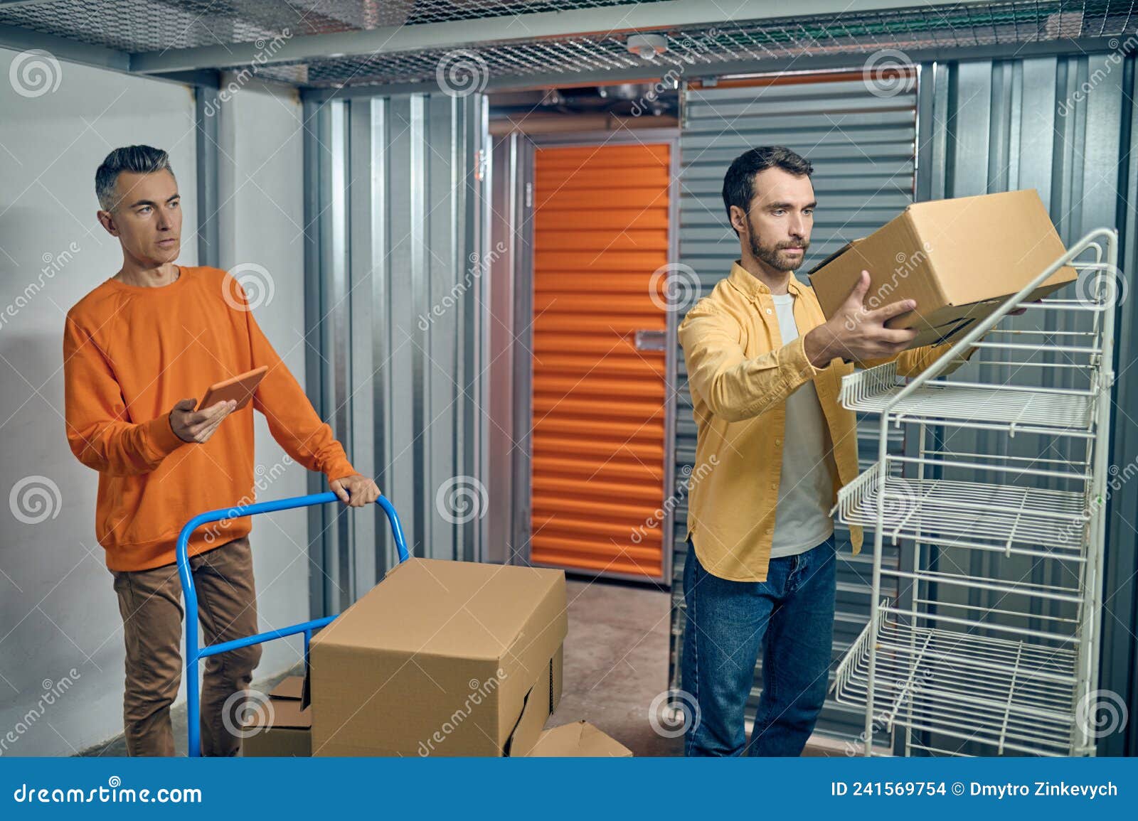 Two Storehouse Employees Unloading Goods in the Storage Room Stock ...