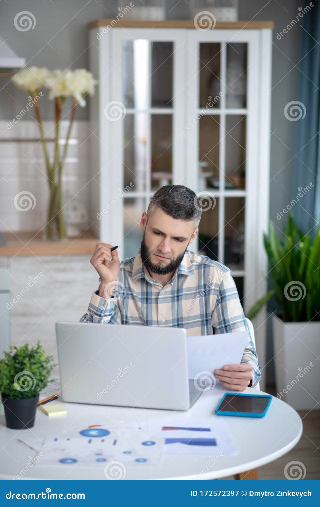 Focused Young Man Looking at a Diagram in His Hand. Stock Image - Image ...