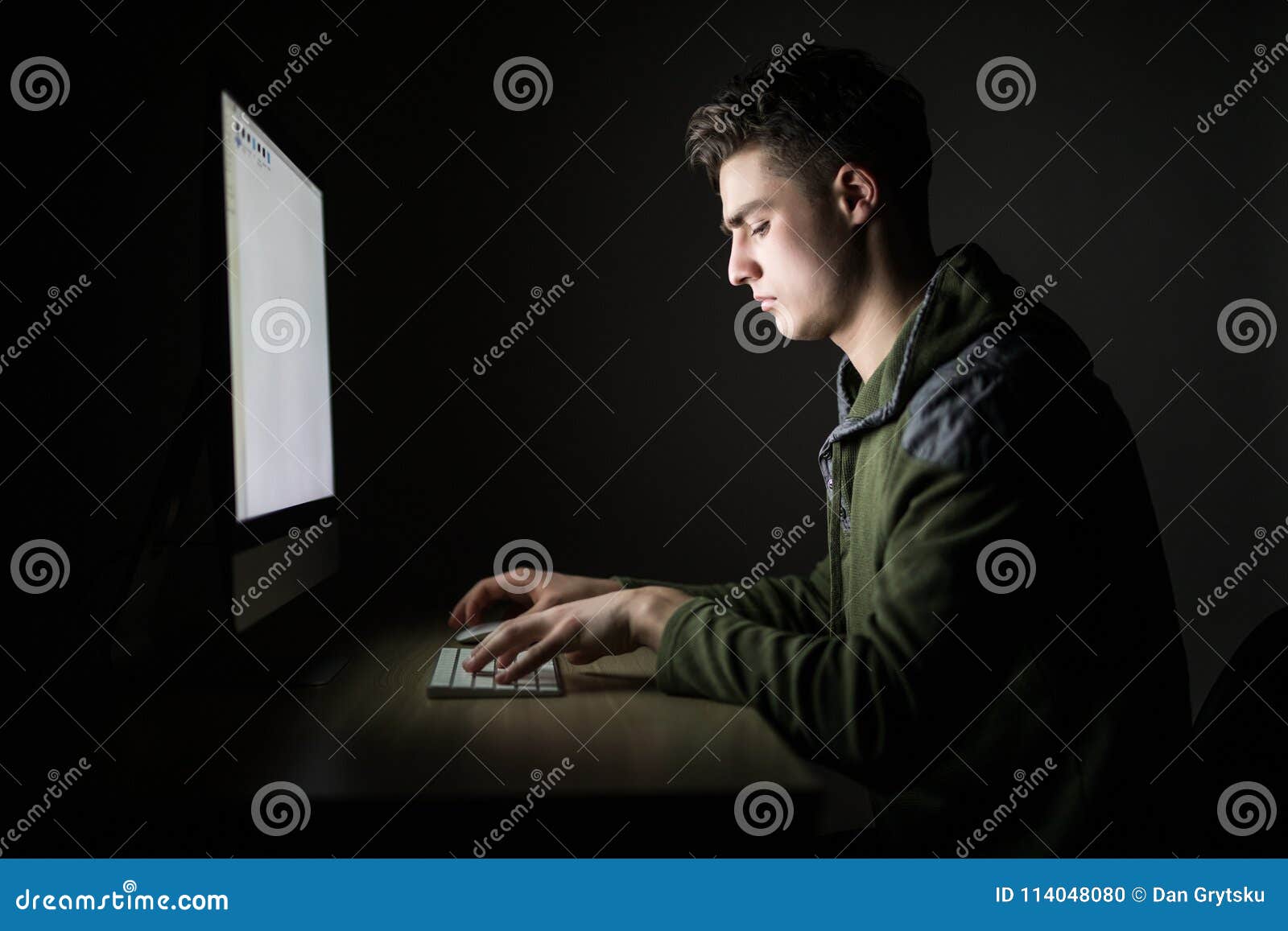 Focused Handsome Young Man Using Computer in Dark Room at Home Stock ...