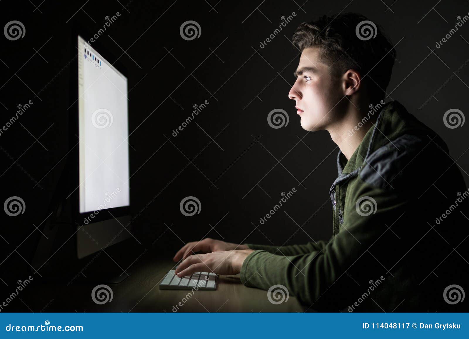 Focused Handsome Young Man Using Computer in Dark Room at Home Stock ...