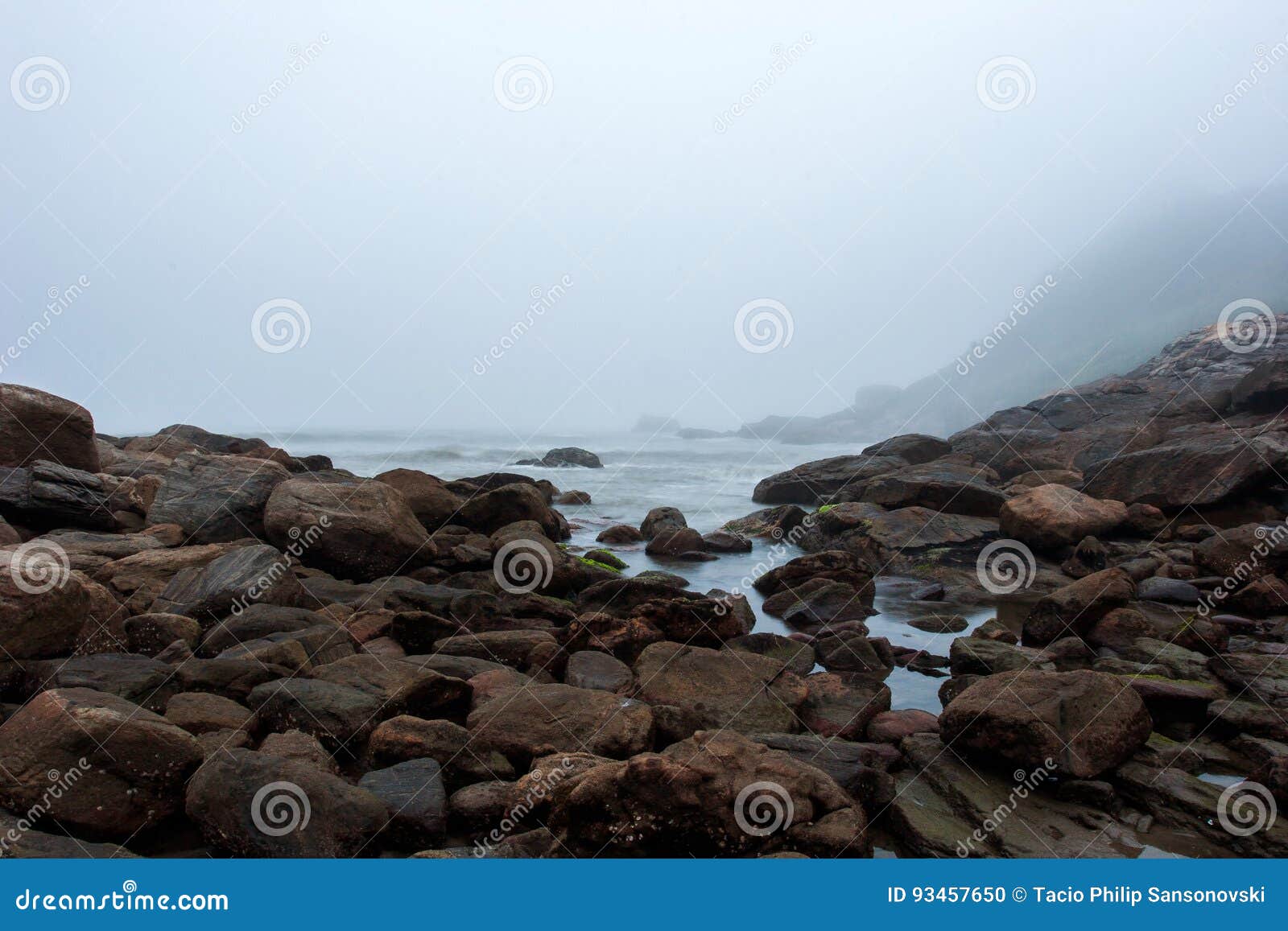 Foggy Beach with Rocks and Mist at Nightfall Stock Photo - Image of ...