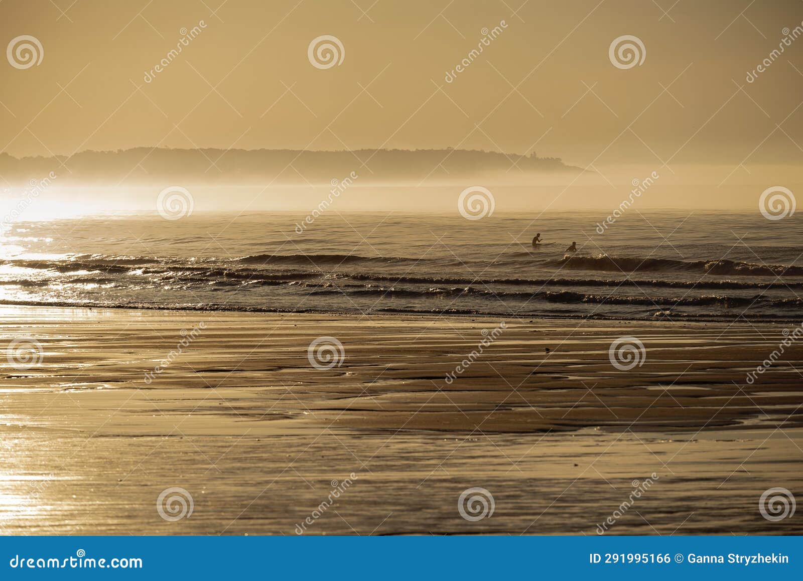 Foggy Coast of the Atlantic Ocean at Dawn and Surfers Stock Photo ...