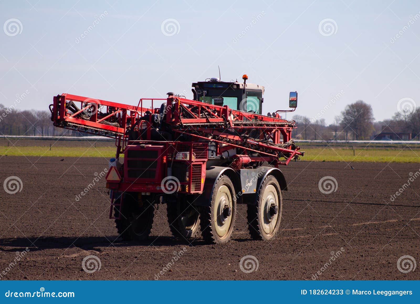 Red Spray Beam Sprinkler Beam Tractor Rides Royalty-Free Stock Image ...