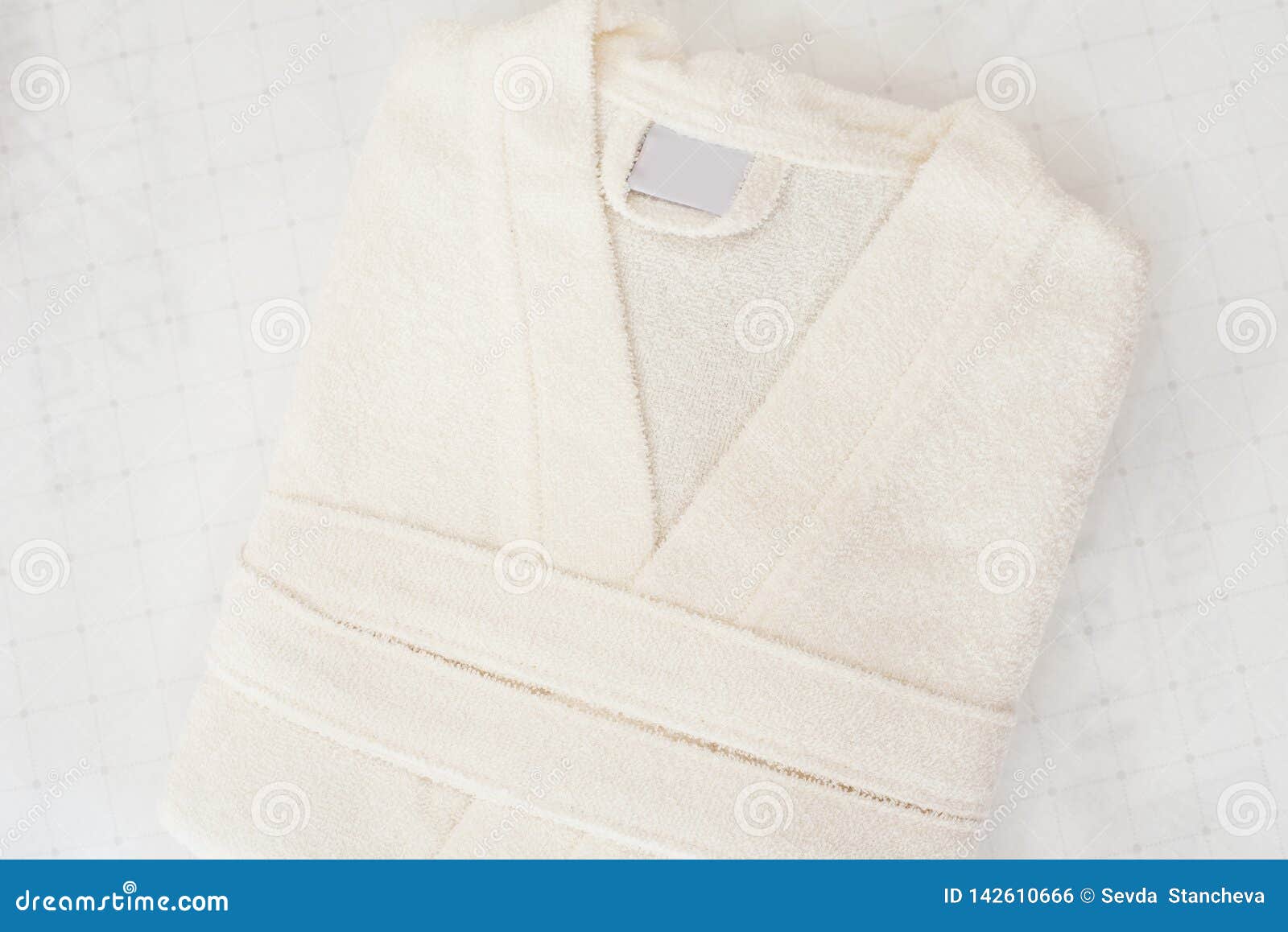 Folded Bathrobe on Bed in Room. White Robe Stock Photo - Image of ...