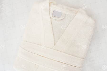 Folded Bathrobe on Bed in Room. White Robe Stock Photo - Image of ...