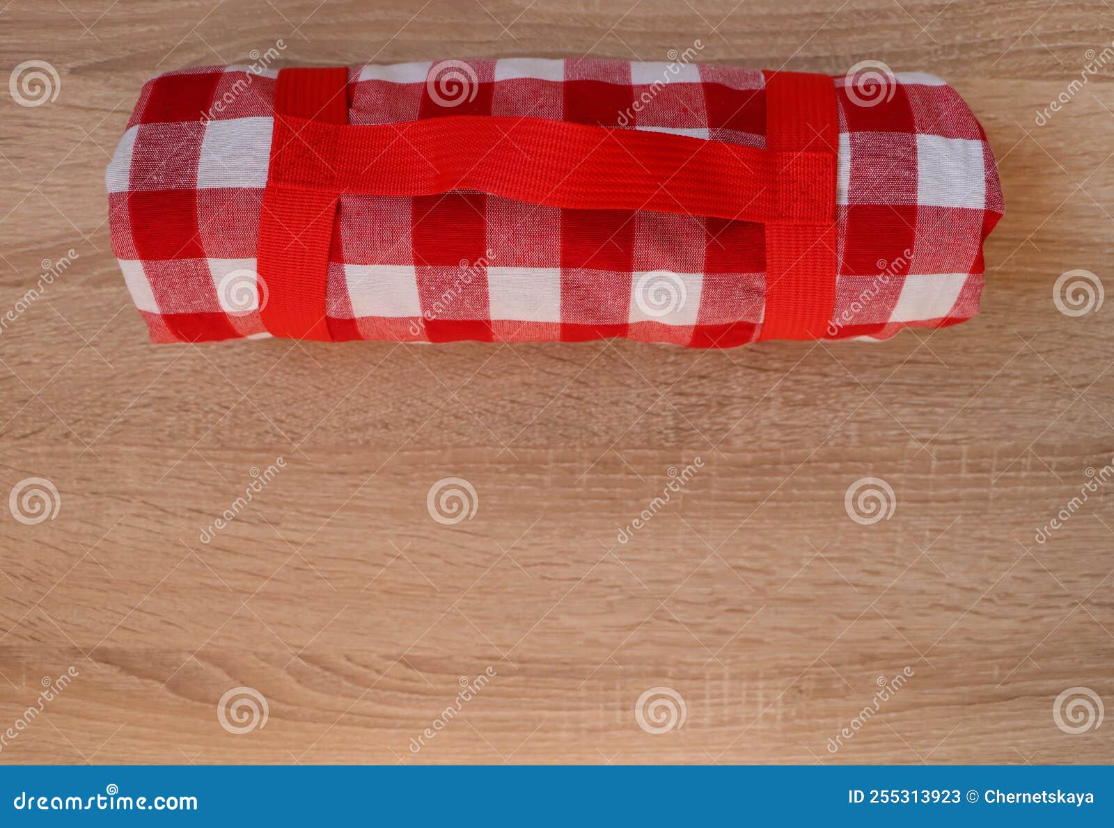 Folded Checkered Picnic Blanket on Wooden Table, Top View. Space for ...