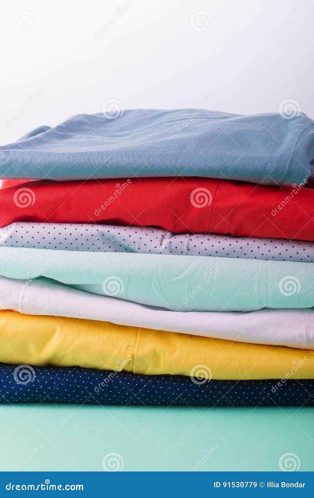 Folded Colorful Pants and Jeans. Stack of Bright Female Trousers. Close ...