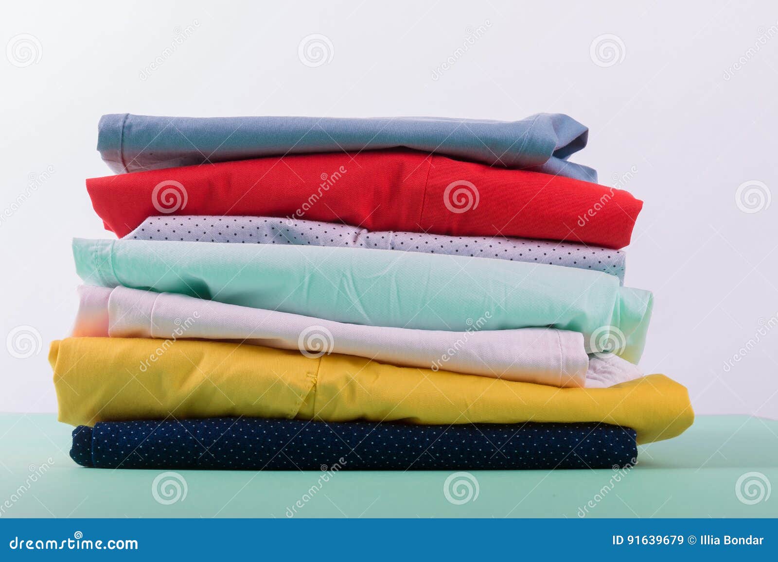 Folded Colorful Pants and Jeans. Stack of Bright Female Trousers. Close ...