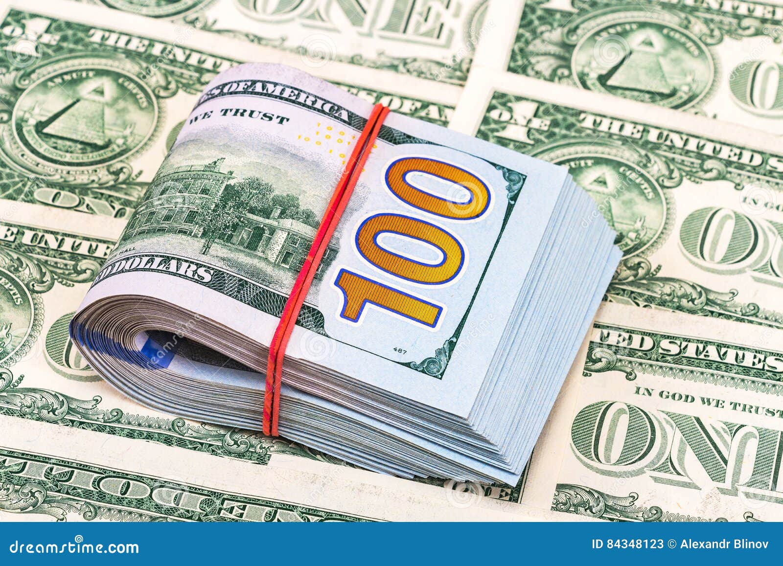Folded Dollar Bills Wrapped by Rubber Band Over Dollars Stock Image ...
