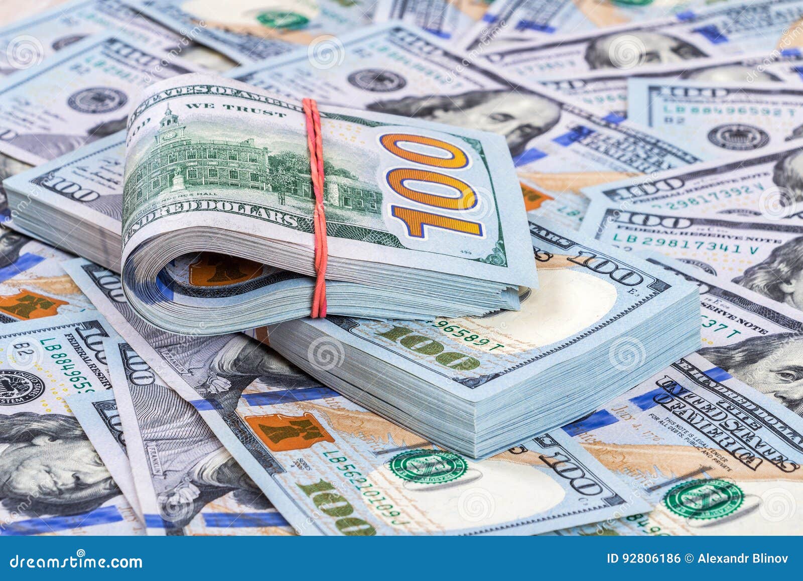 Folded Dollar Bills Wrapped by Rubber Band Over Dollars Stock Photo ...