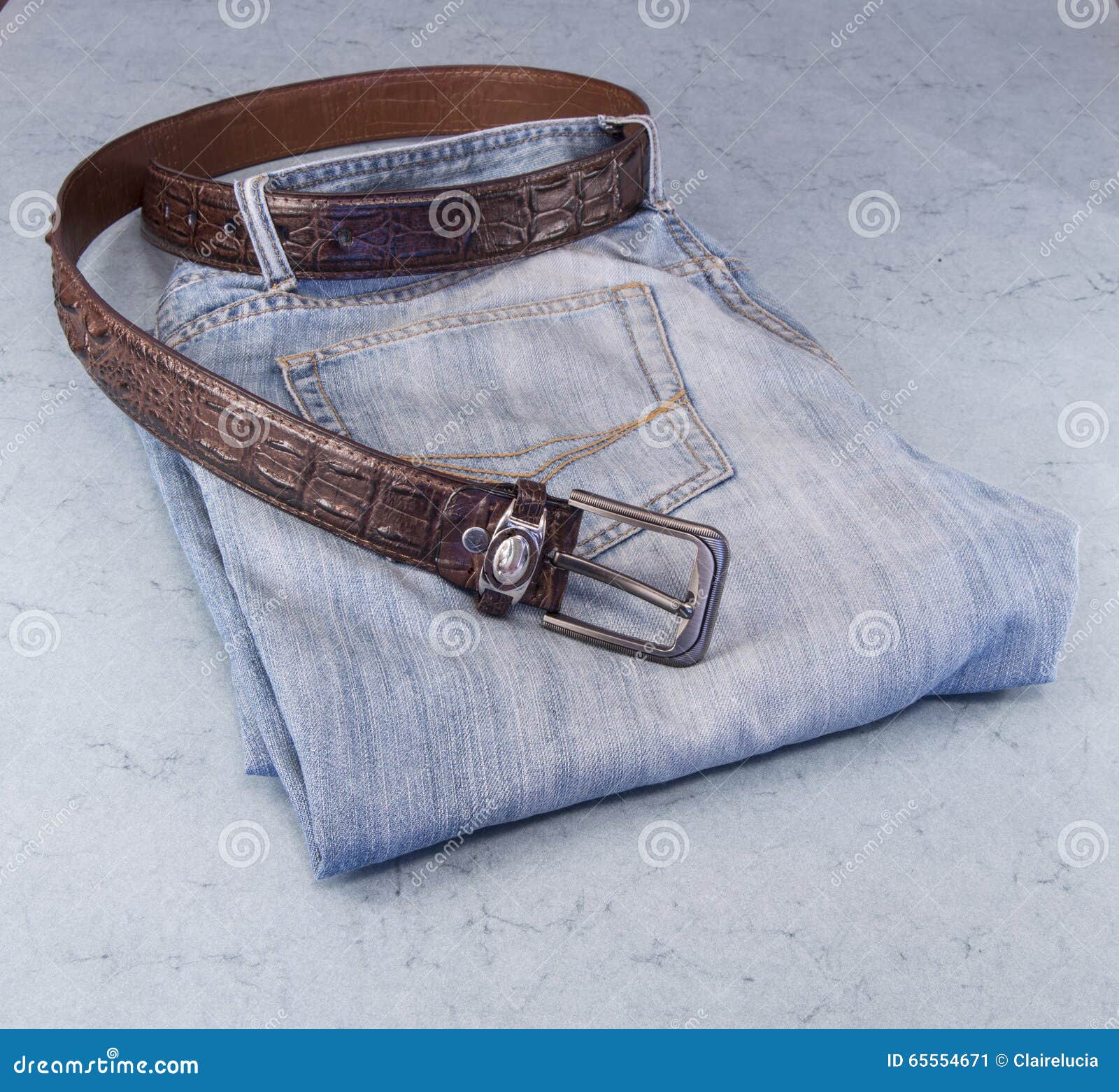 Folded Men S Jeans with Leather Belt on Blue Background Stock Image ...